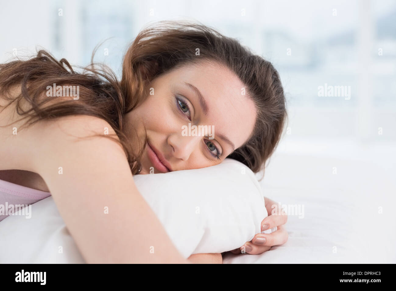 Close up portrait of a pretty woman resting in bed Stock Photo - Alamy