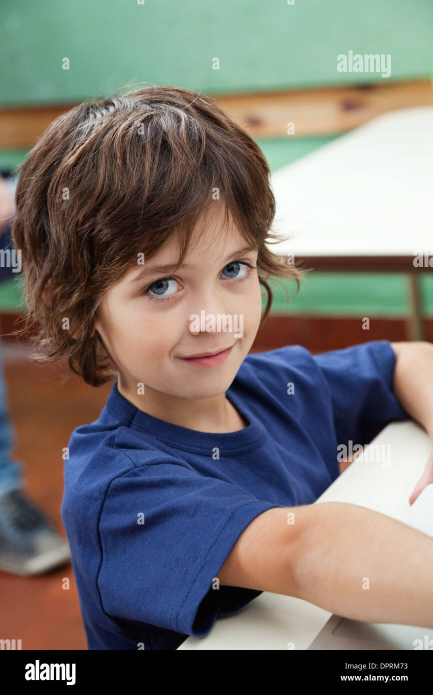Little Boy Smiling At Desk Stock Photo - Alamy