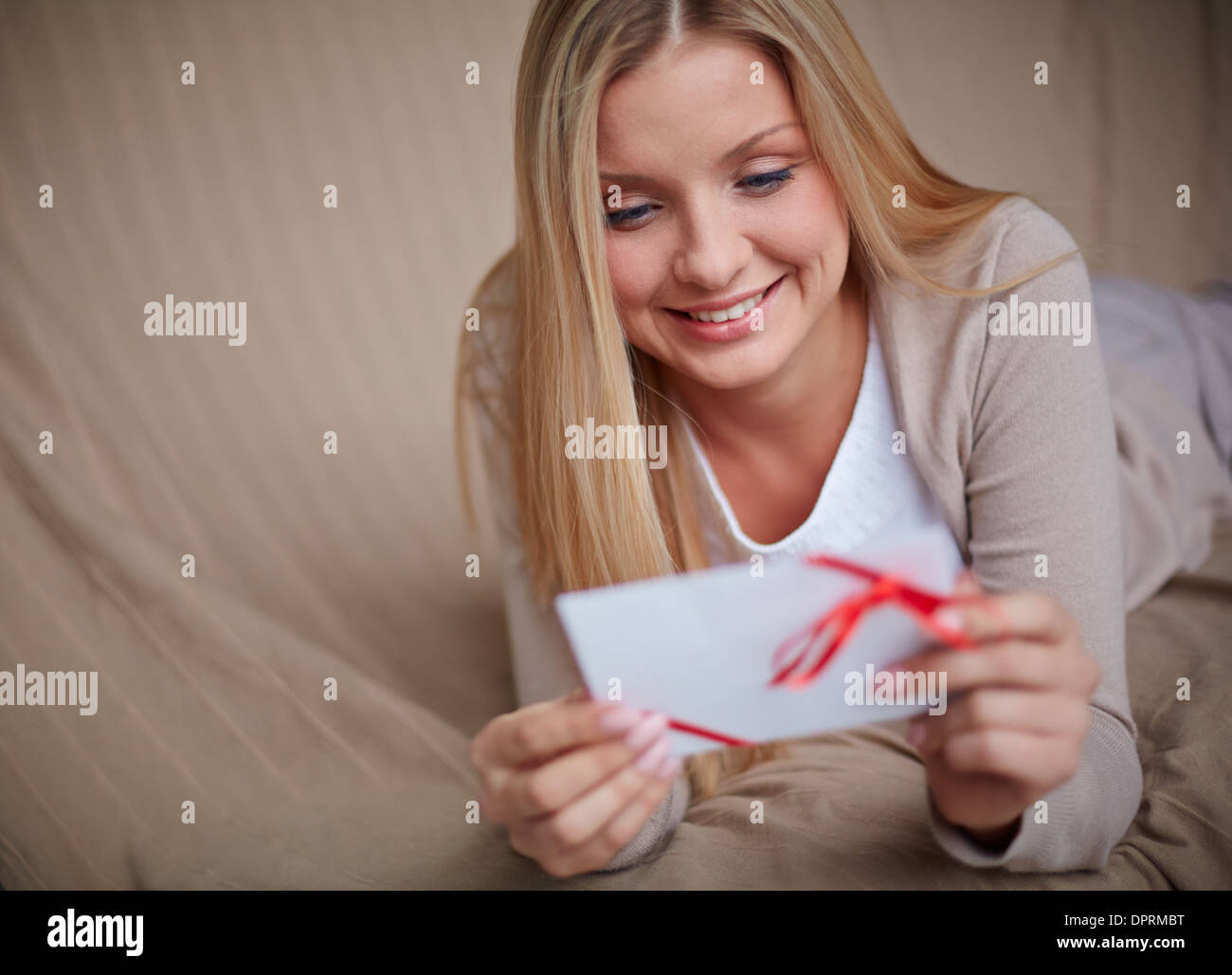 Image of smiling female reading valentine message Stock Photo - Alamy
