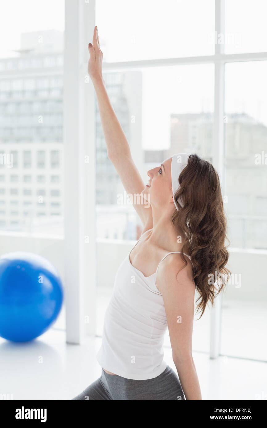 Fit woman stretching hand in fitness studio Stock Photo - Alamy