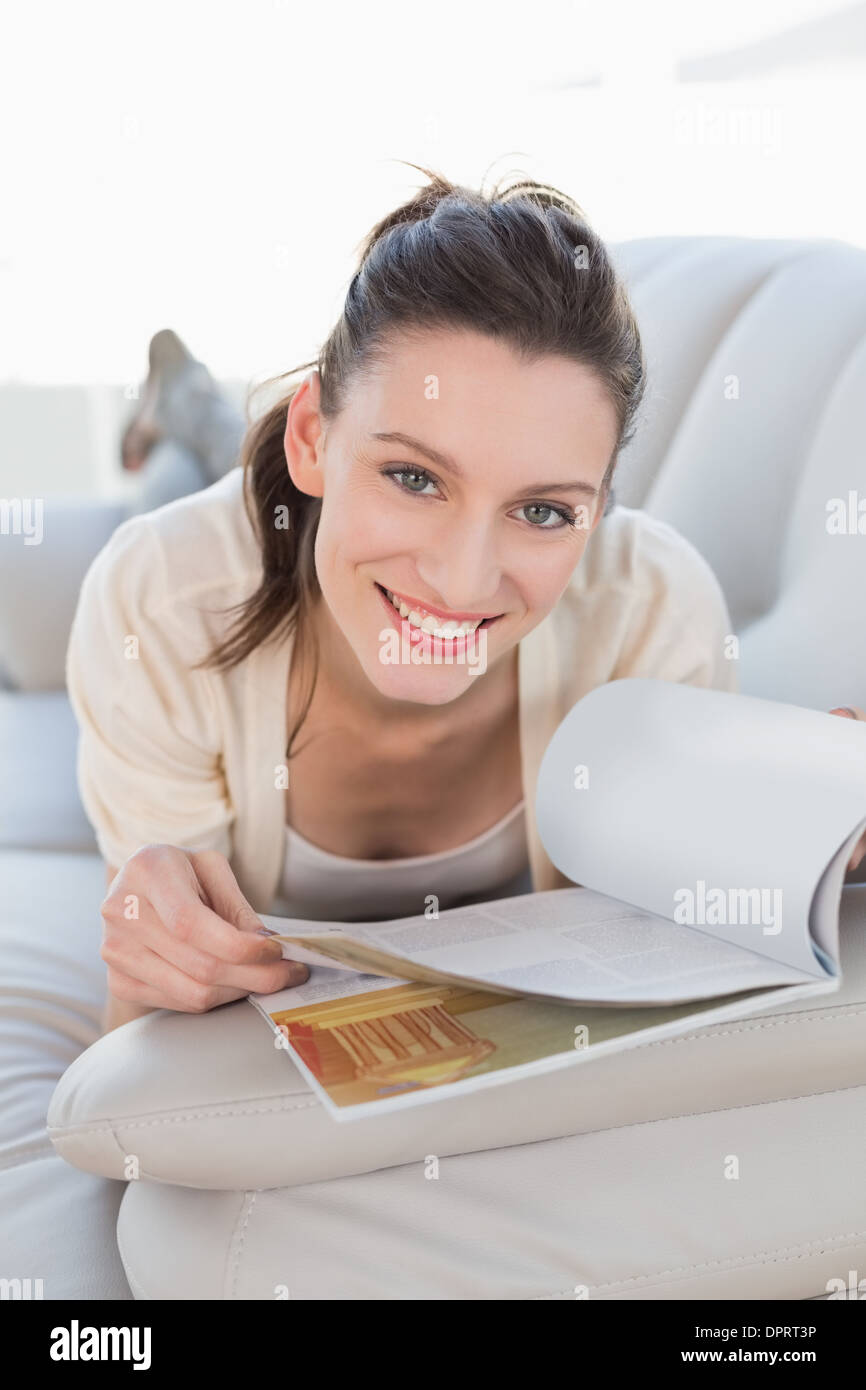Portrait of a casual woman reading a book on sofa Stock Photo - Alamy