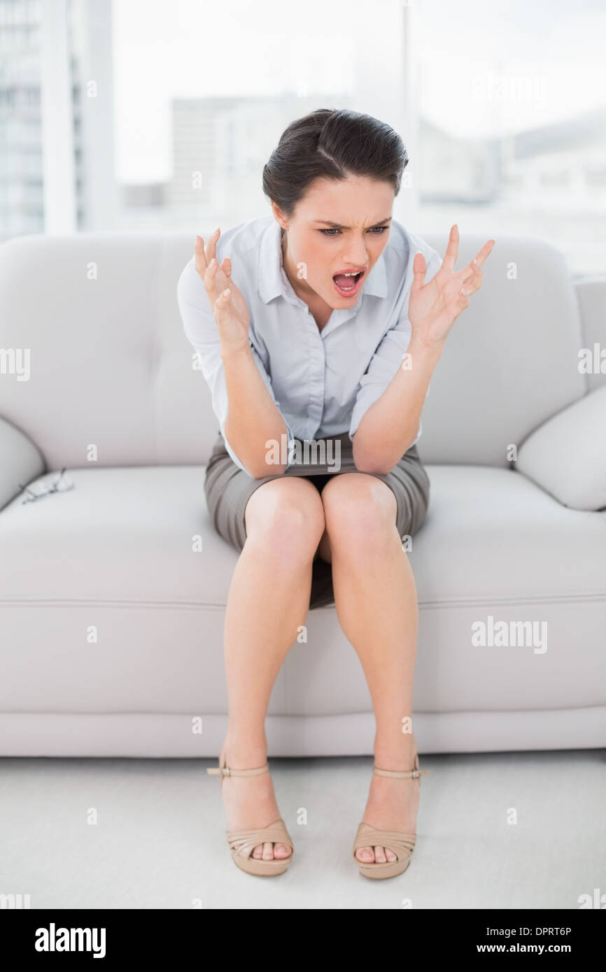 Elegant woman shouting in anger at home Stock Photo - Alamy
