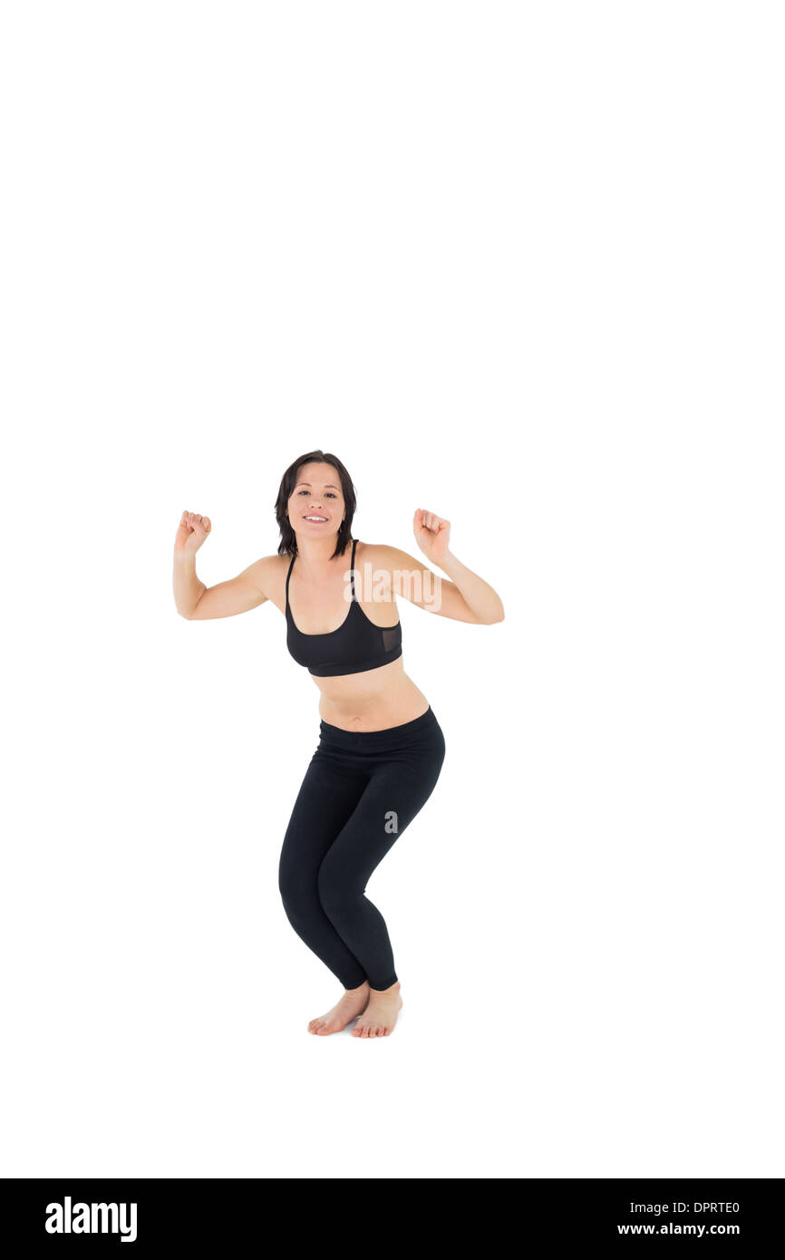 Sporty young woman about to jump over white background Stock Photo - Alamy