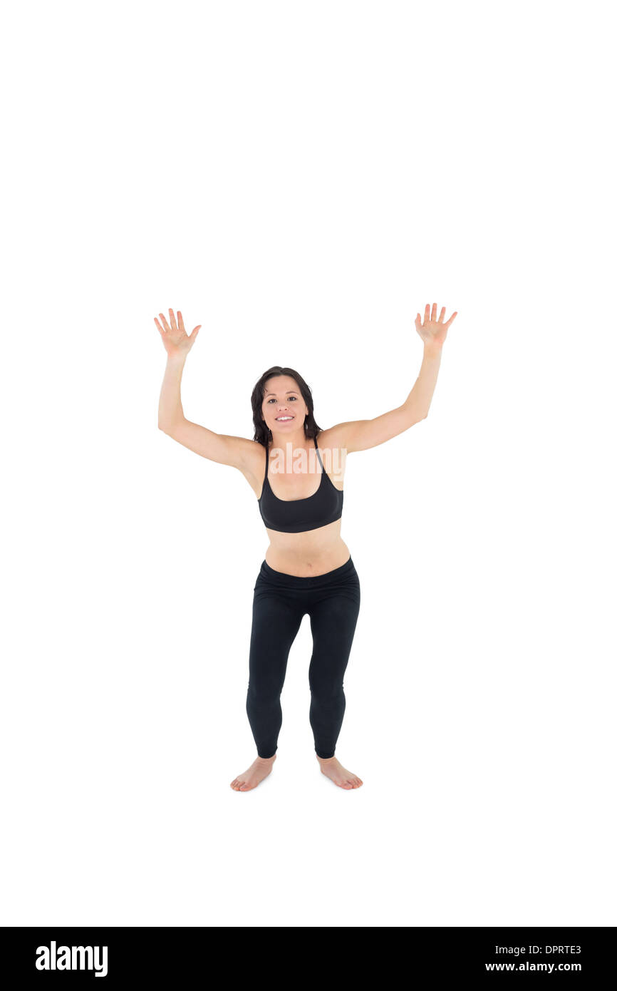 Sporty young woman about to jump over white background Stock Photo - Alamy