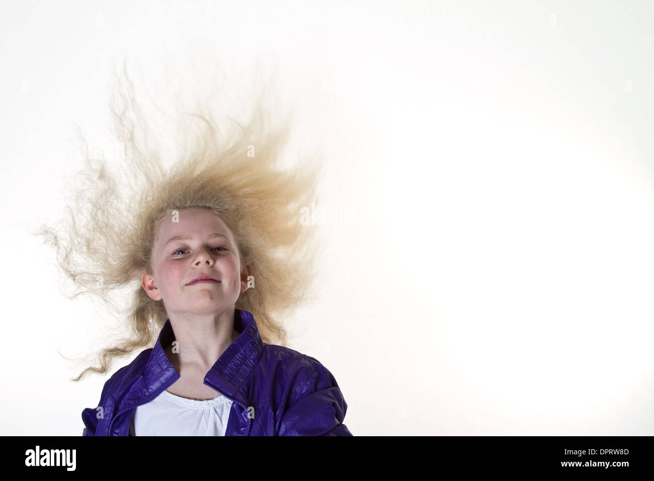 Girl dancing with hair in the air white background; shot in studio ...