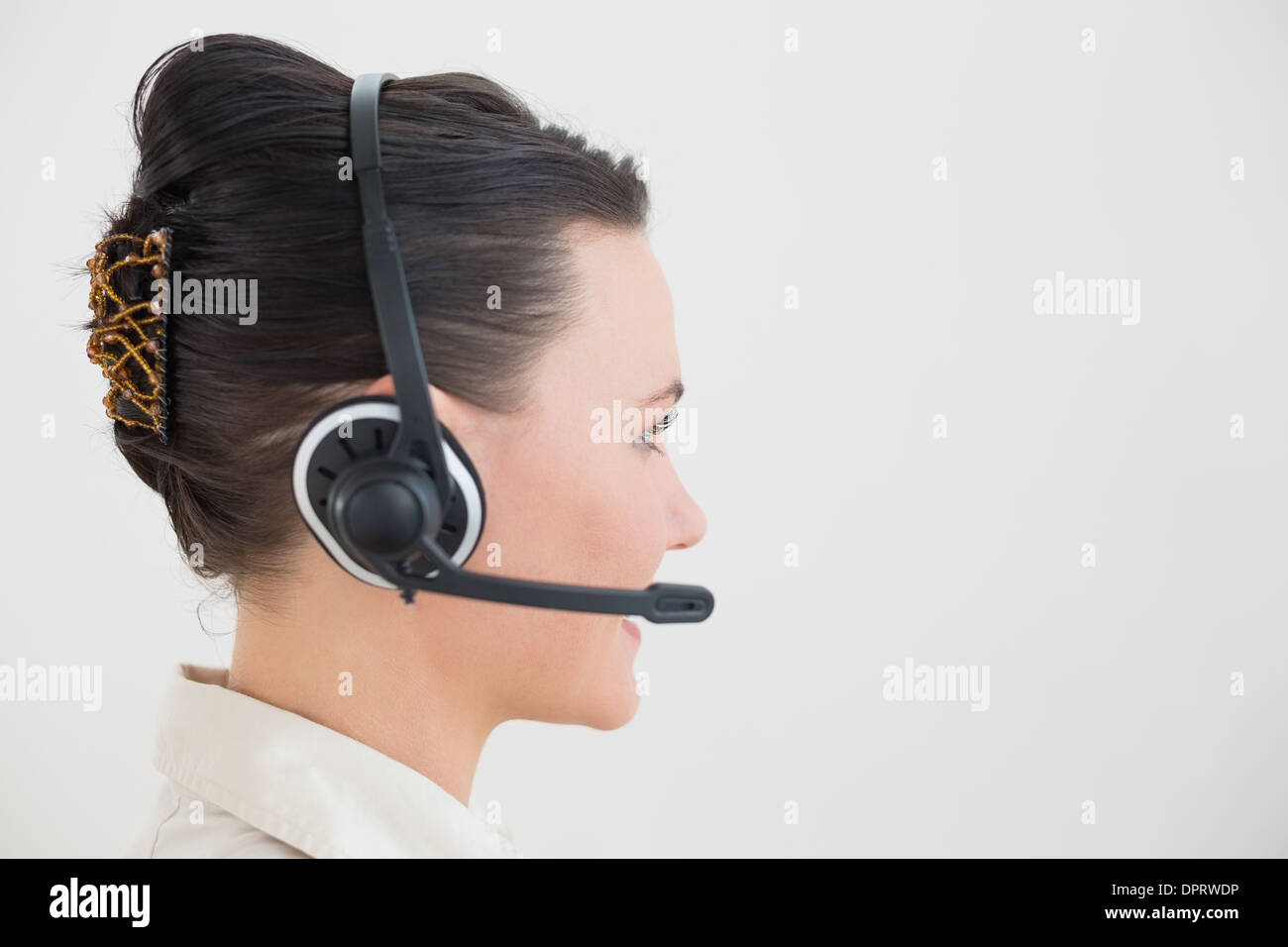 Side view of a beautiful businesswoman using headset Stock Photo - Alamy