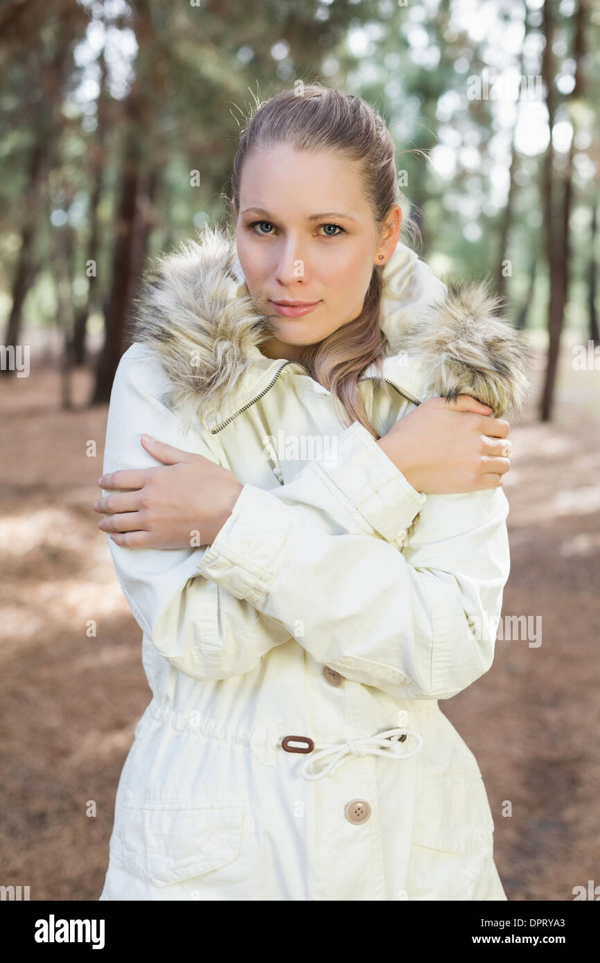 Cute woman shivering while having a walk in a forest Stock Photo - Alamy