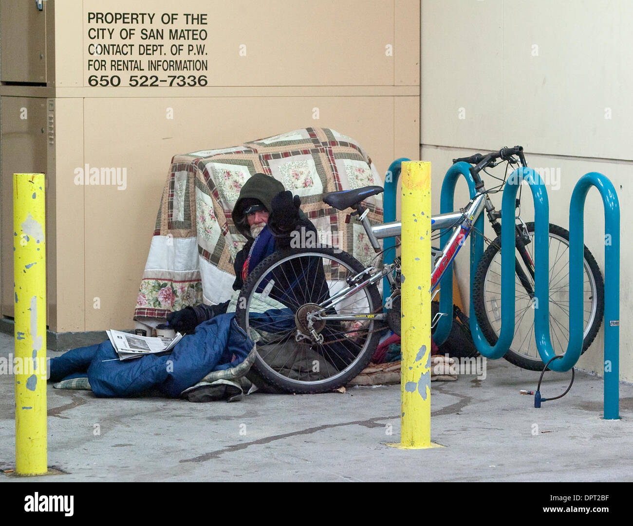 A homeless man hangs out in a downtown parking garage in San Mateo ...