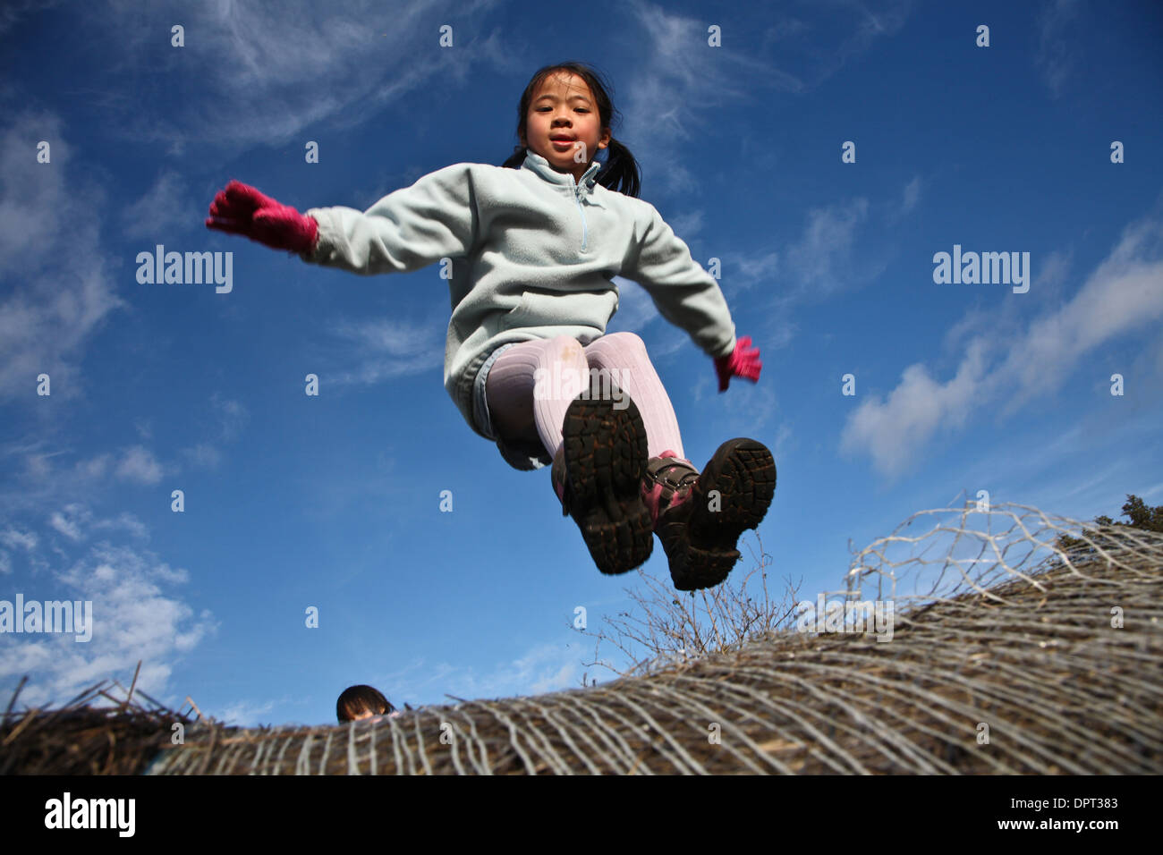 happy child outdoor jumping a summer day against a blue sky Stock Photo ...