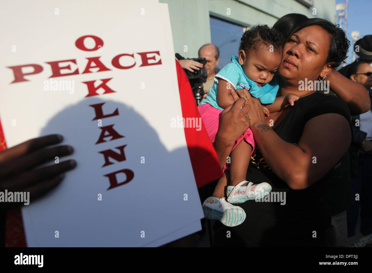 Jennifer Hopwood holds onto her daughter, Sky Hanks, 1, during a vigil ...