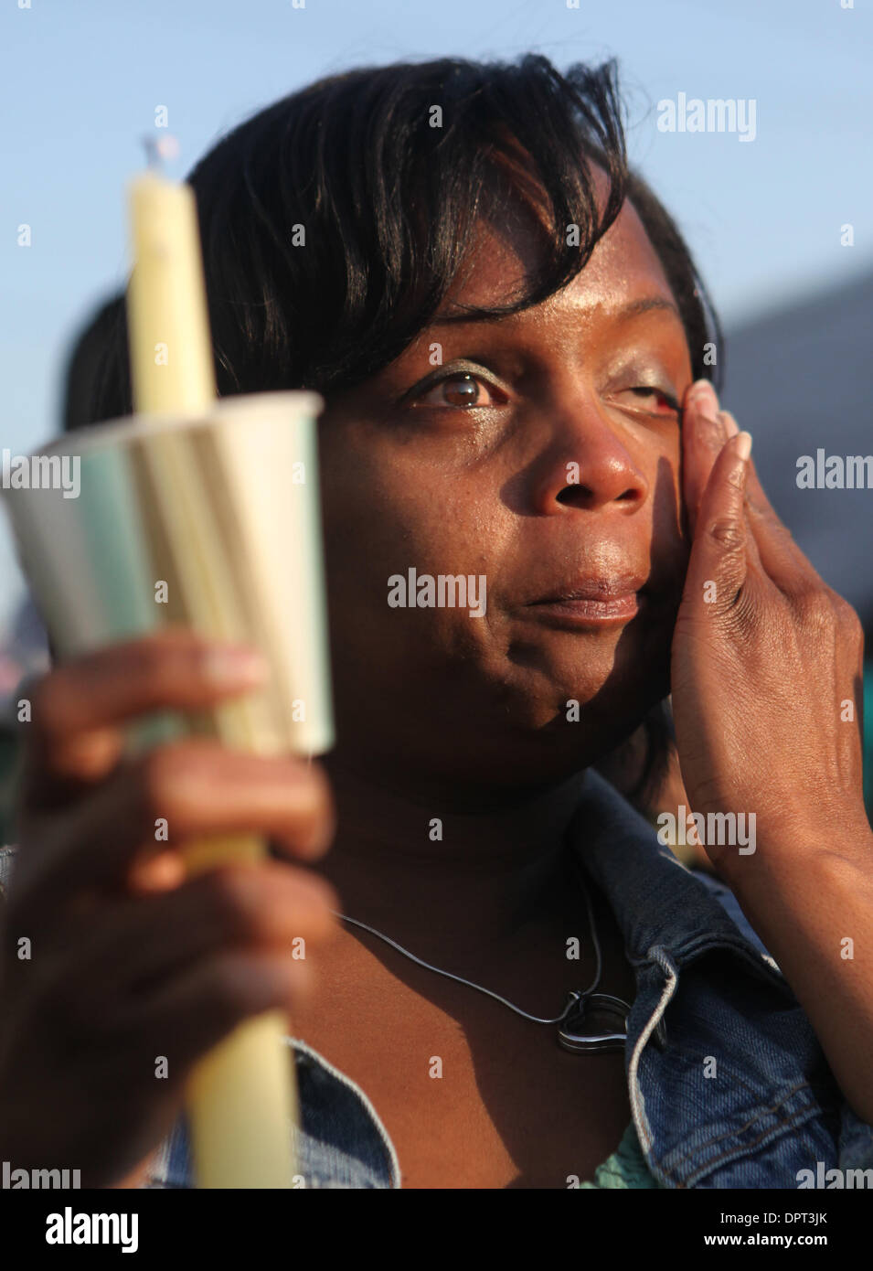 Oakland resident Janine Jefferson sheds a tear during a vigil to honor ...