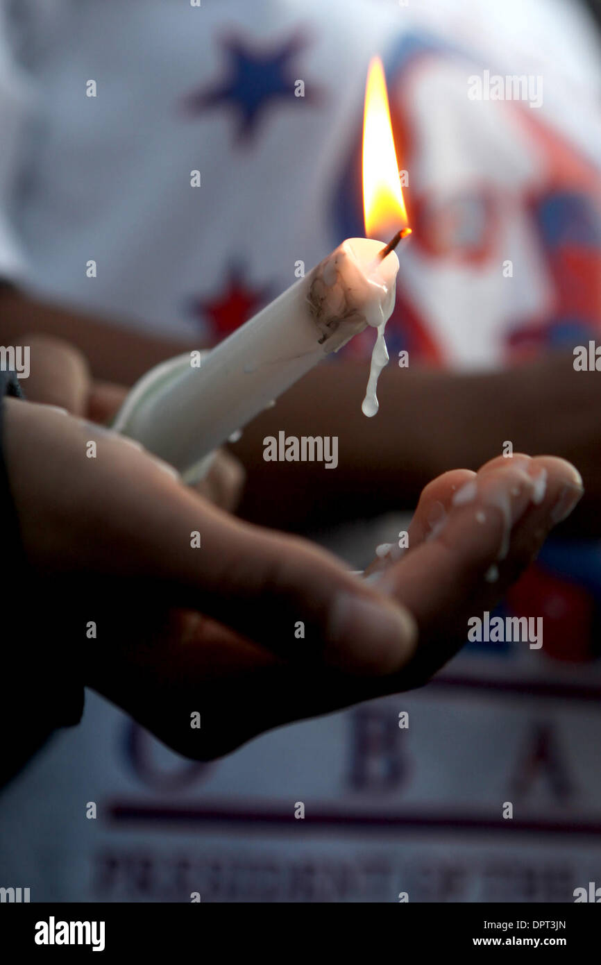 Isaiah Chatman, 11, holds a candle during a vigil to honor the four ...