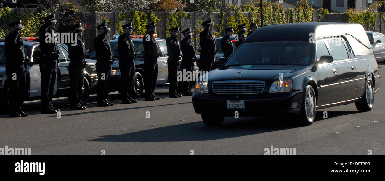 Members of the Tracy Police salute as a hearse carrying the body of ...