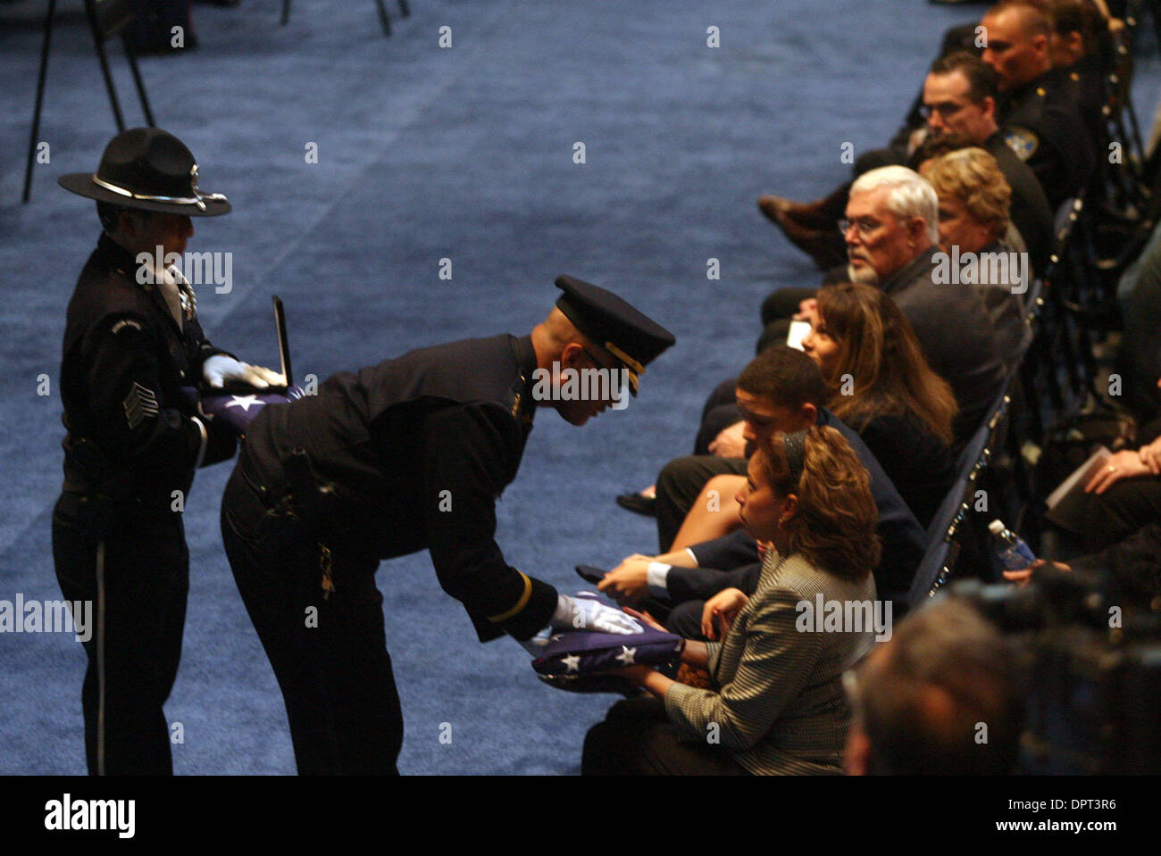 Oakland Police Chief Howard Jordan gives a flag to the wife of Sgt ...