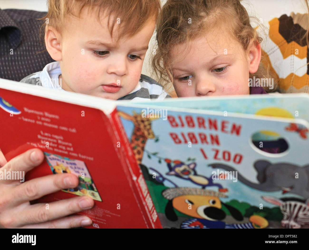 family: brother and sister: reading Stock Photo - Alamy