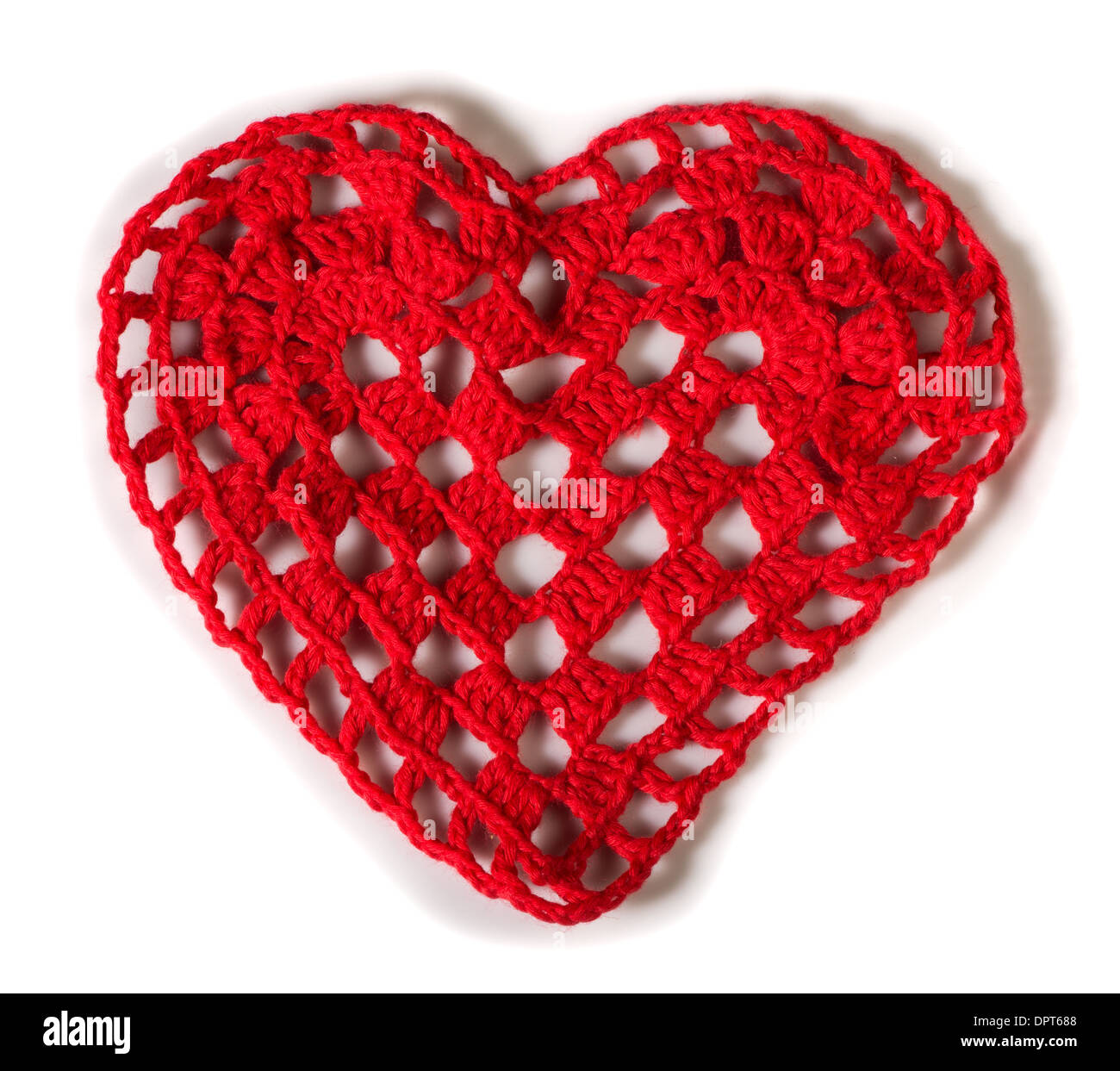 Knitted red heart made of yarn. White isolated Stock Photo - Alamy