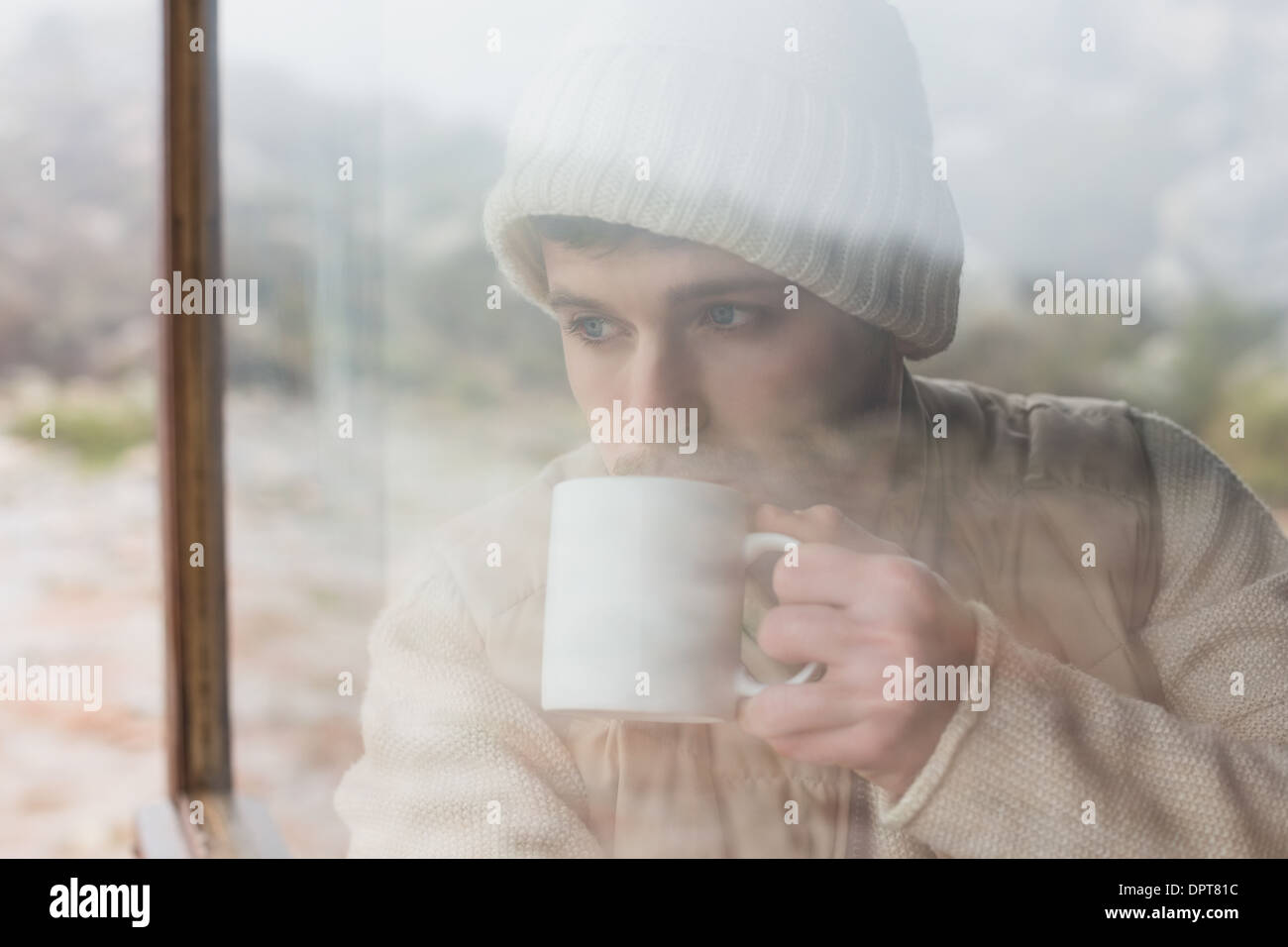 Man drinking coffee seen through cabin window Stock Photo - Alamy