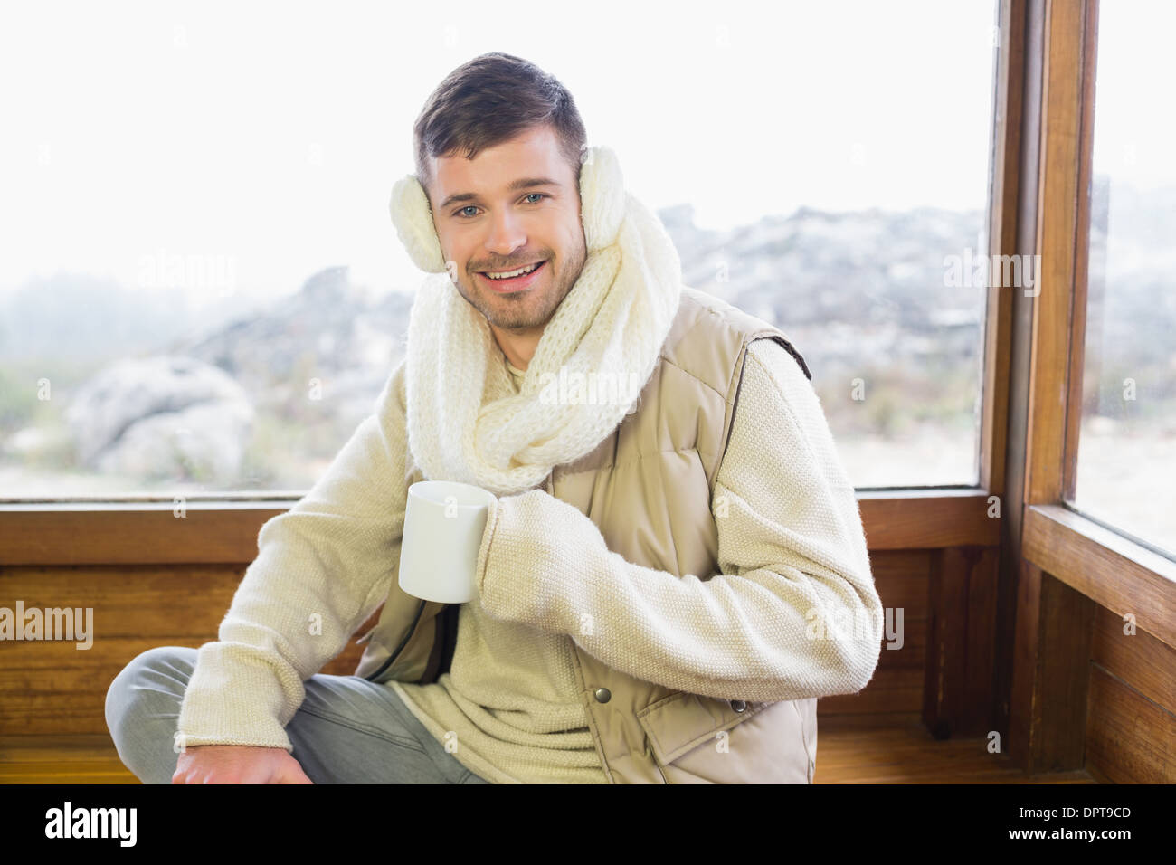 Smiling man sitting against window hi-res stock photography and images ...