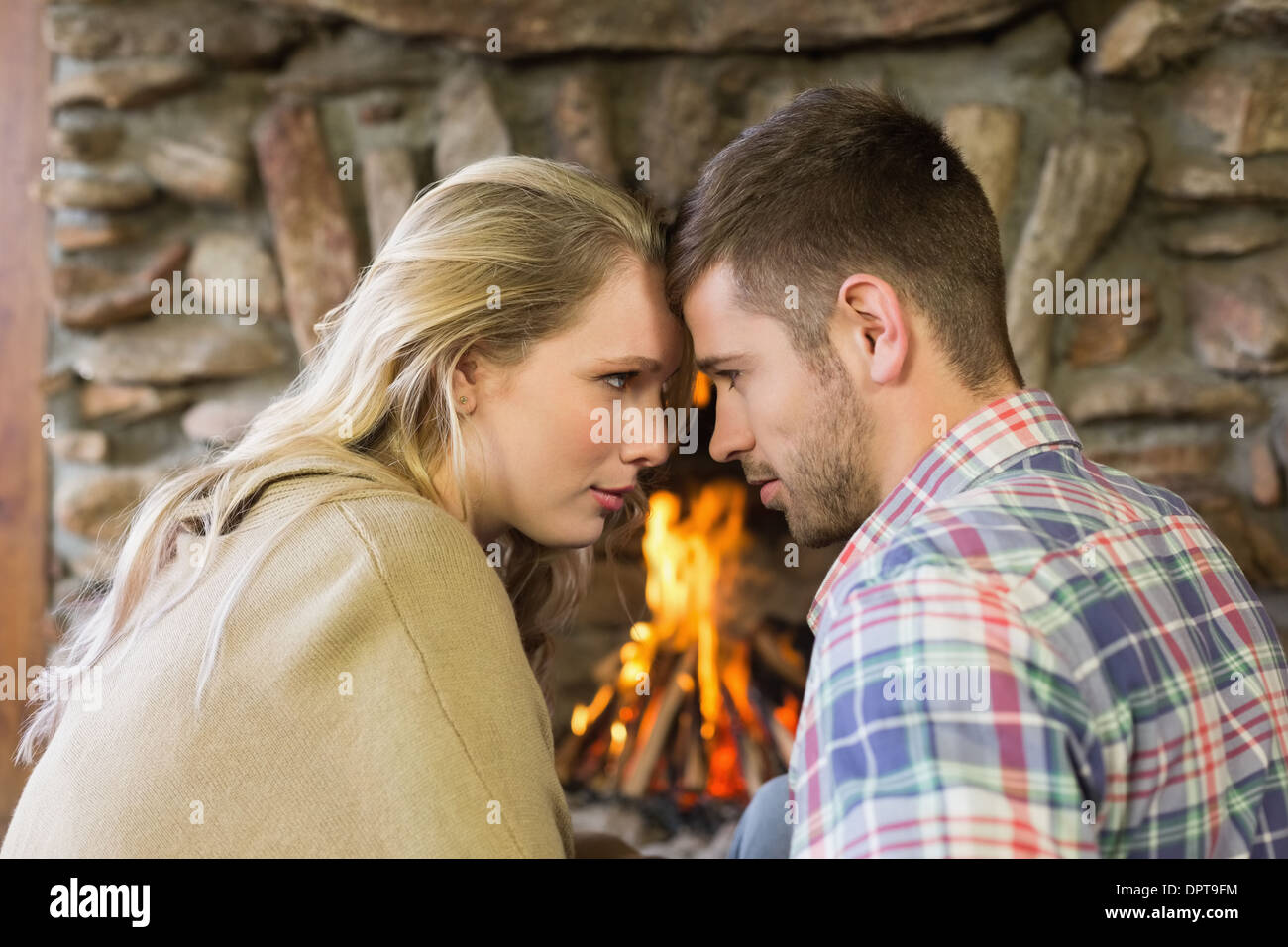 Couple sitting in front of fire hi-res stock photography and images - Alamy