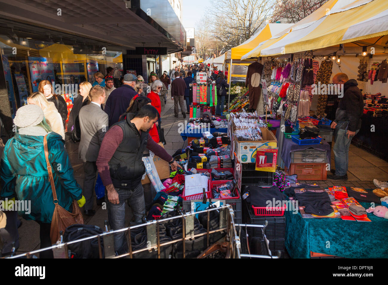 Shoppers browsing market stalls in town centre high street Stock Photo ...