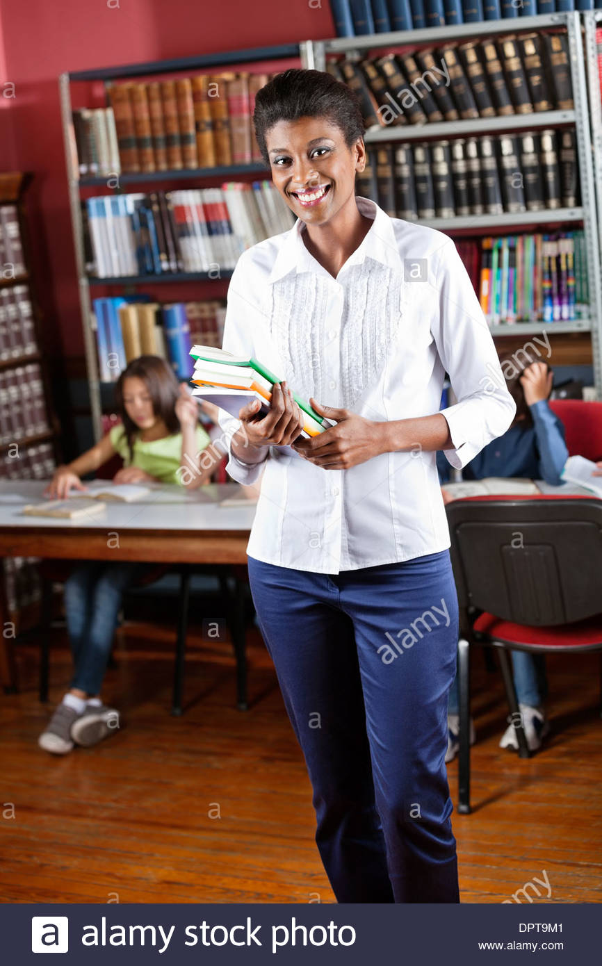 Librarian Holding Books Standing In High Resolution Stock Photography ...