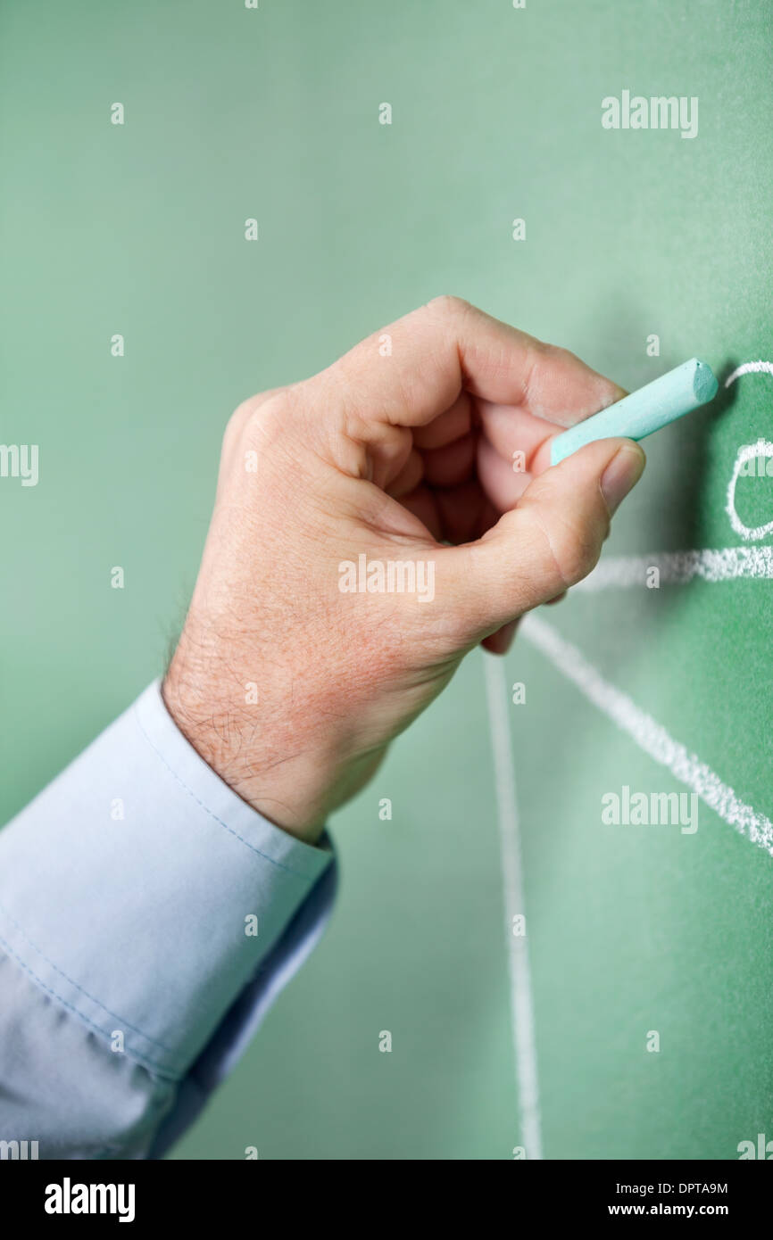 Male Professor Writing On Greenboard Stock Photo - Alamy