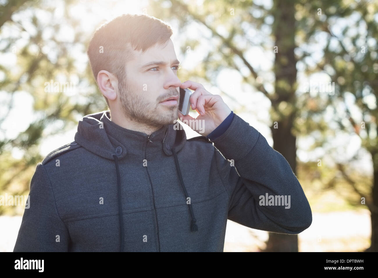 Serious man using mobile phone outdoors Stock Photo - Alamy