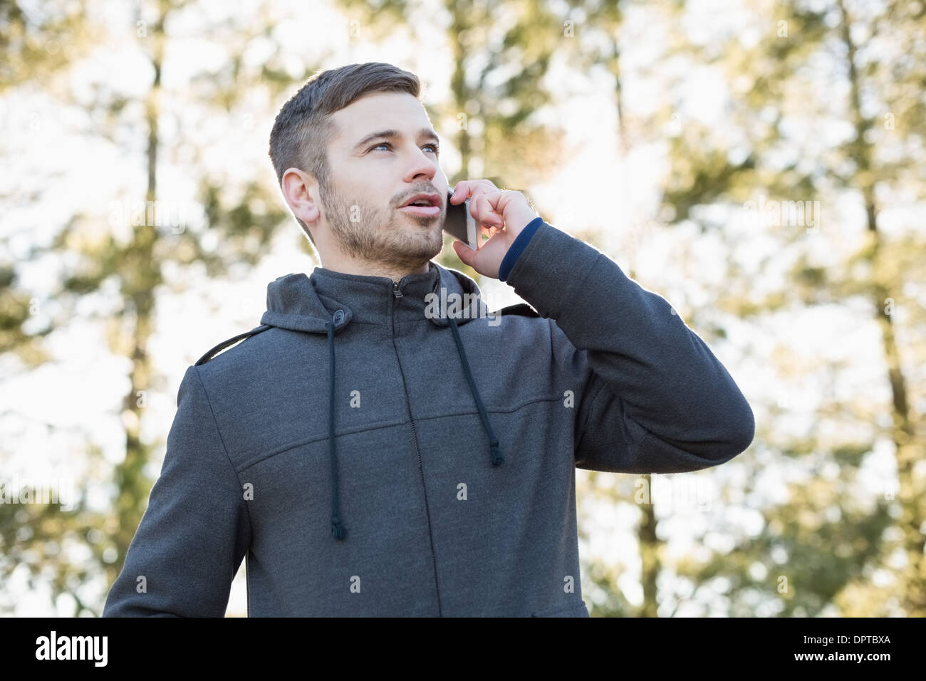 Serious man using mobile phone outdoors Stock Photo - Alamy