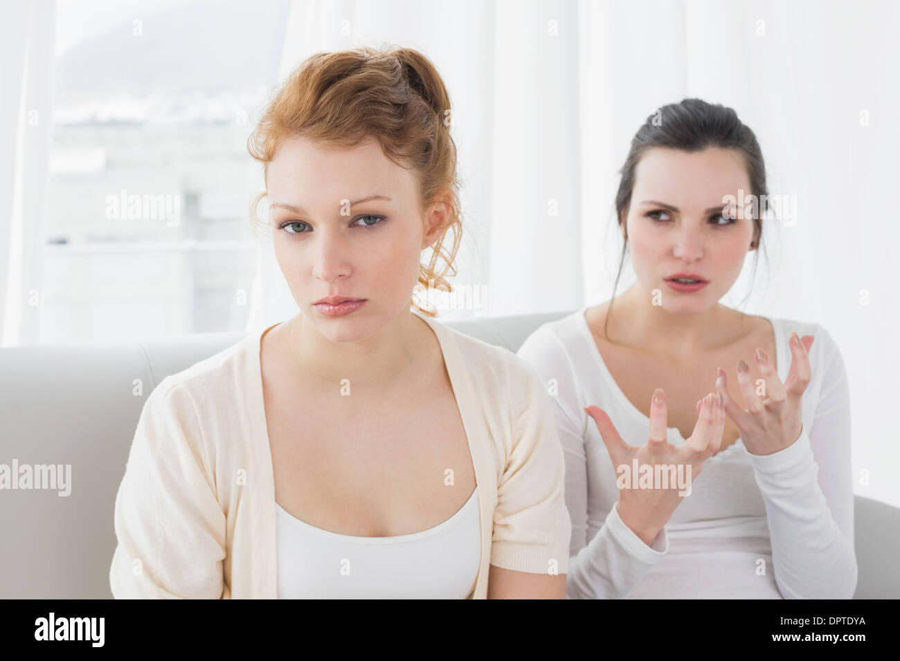 Angry friends having an argument in the living room Stock Photo - Alamy