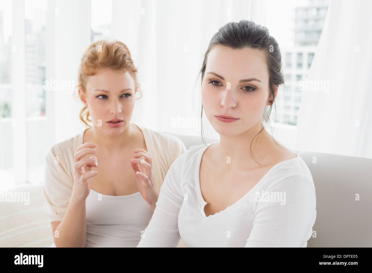 Angry friends having an argument in the living room Stock Photo - Alamy