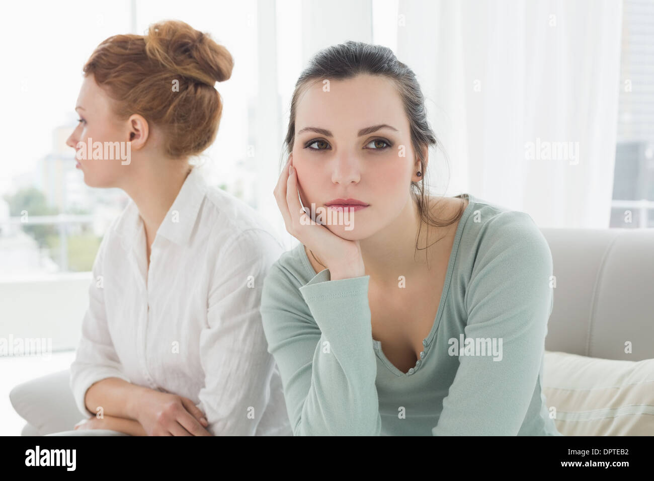 Unhappy friends not talking after argument on the couch Stock Photo - Alamy