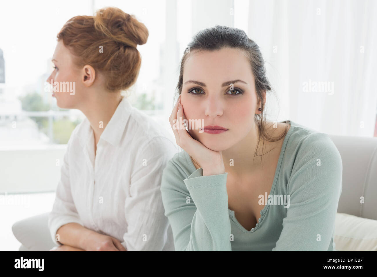 Unhappy friends not talking after argument on the couch Stock Photo - Alamy
