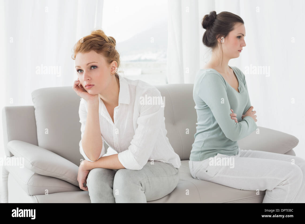 Unhappy friends not talking after argument on the couch Stock Photo - Alamy