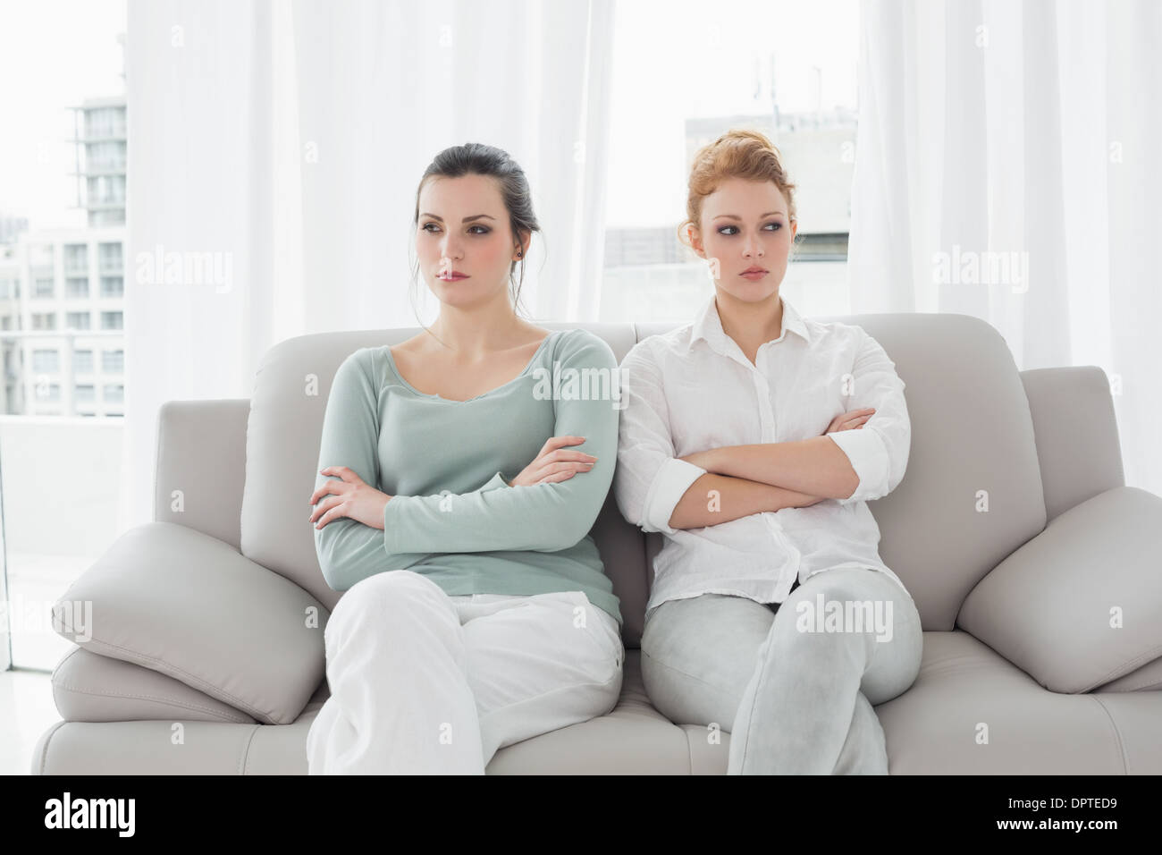 Unhappy friends not talking after argument on the couch Stock Photo - Alamy