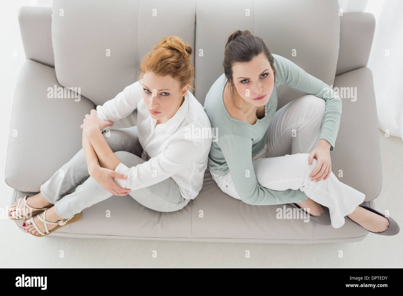 Unhappy female friends not talking after argument on the couch Stock ...