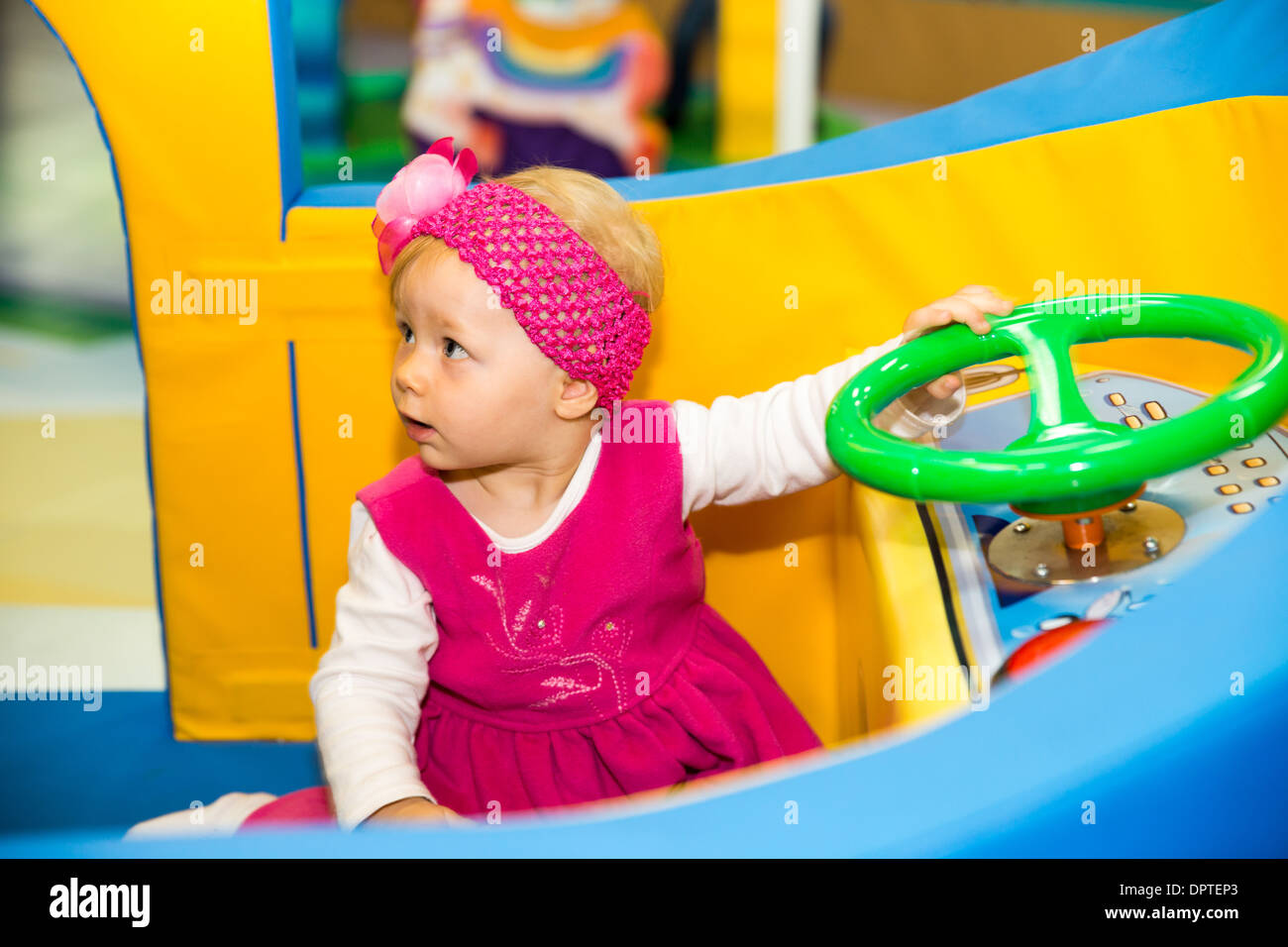 Happy baby girl keep on board ship on playground The concept of ...