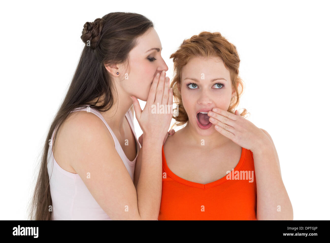 Two young female friends gossiping Stock Photo - Alamy
