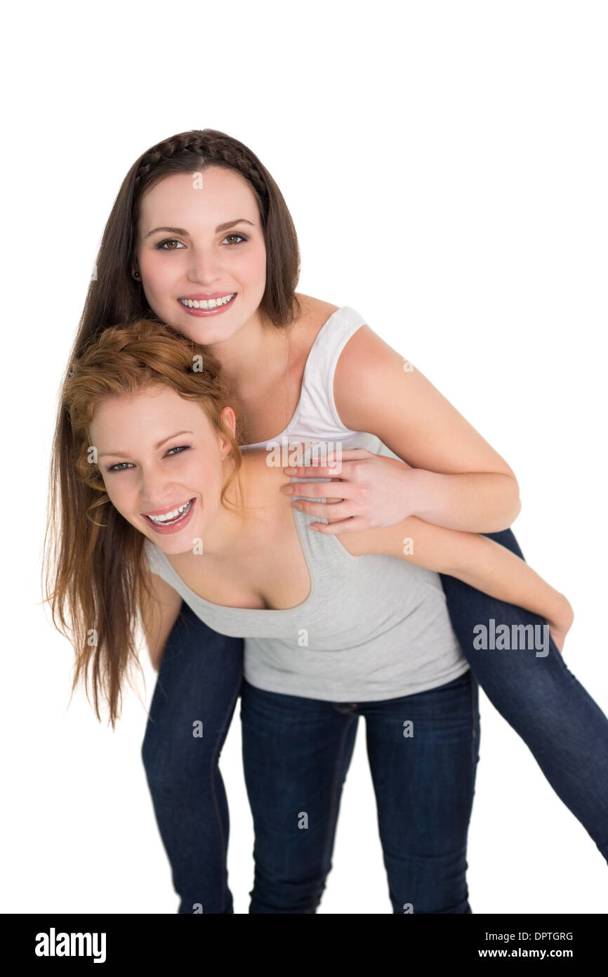 Young woman piggybacking female friend hi-res stock photography and ...