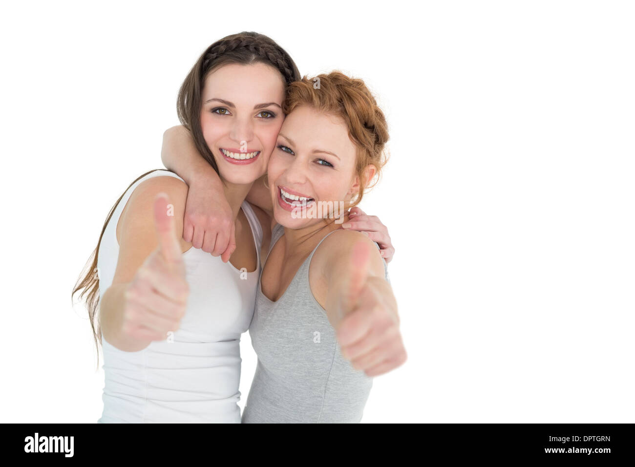 Portrait of two female friends gesturing thumbs up Stock Photo - Alamy