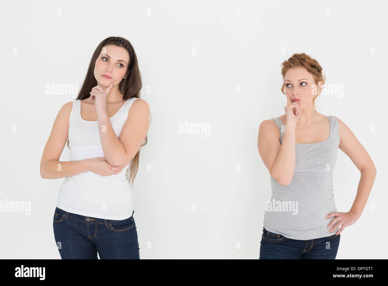 Two young thoughtful female friends standing Stock Photo - Alamy