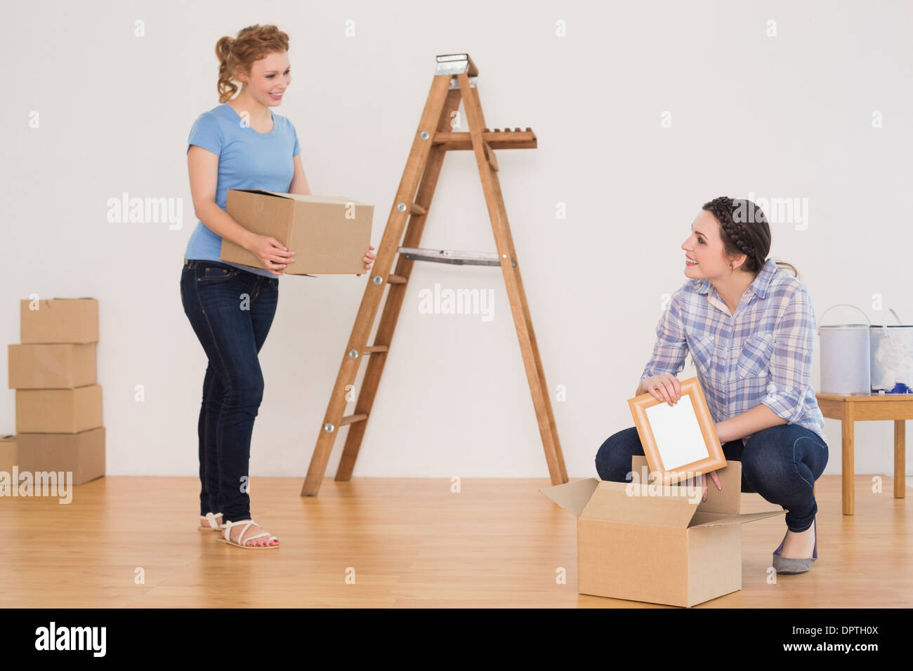 Two friends moving together in a new house Stock Photo - Alamy