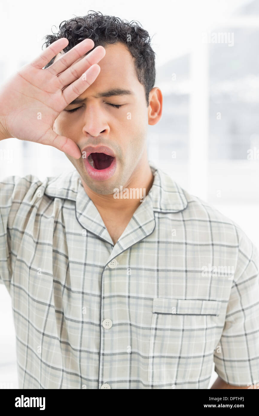 Young man yawning in bed hi-res stock photography and images - Alamy