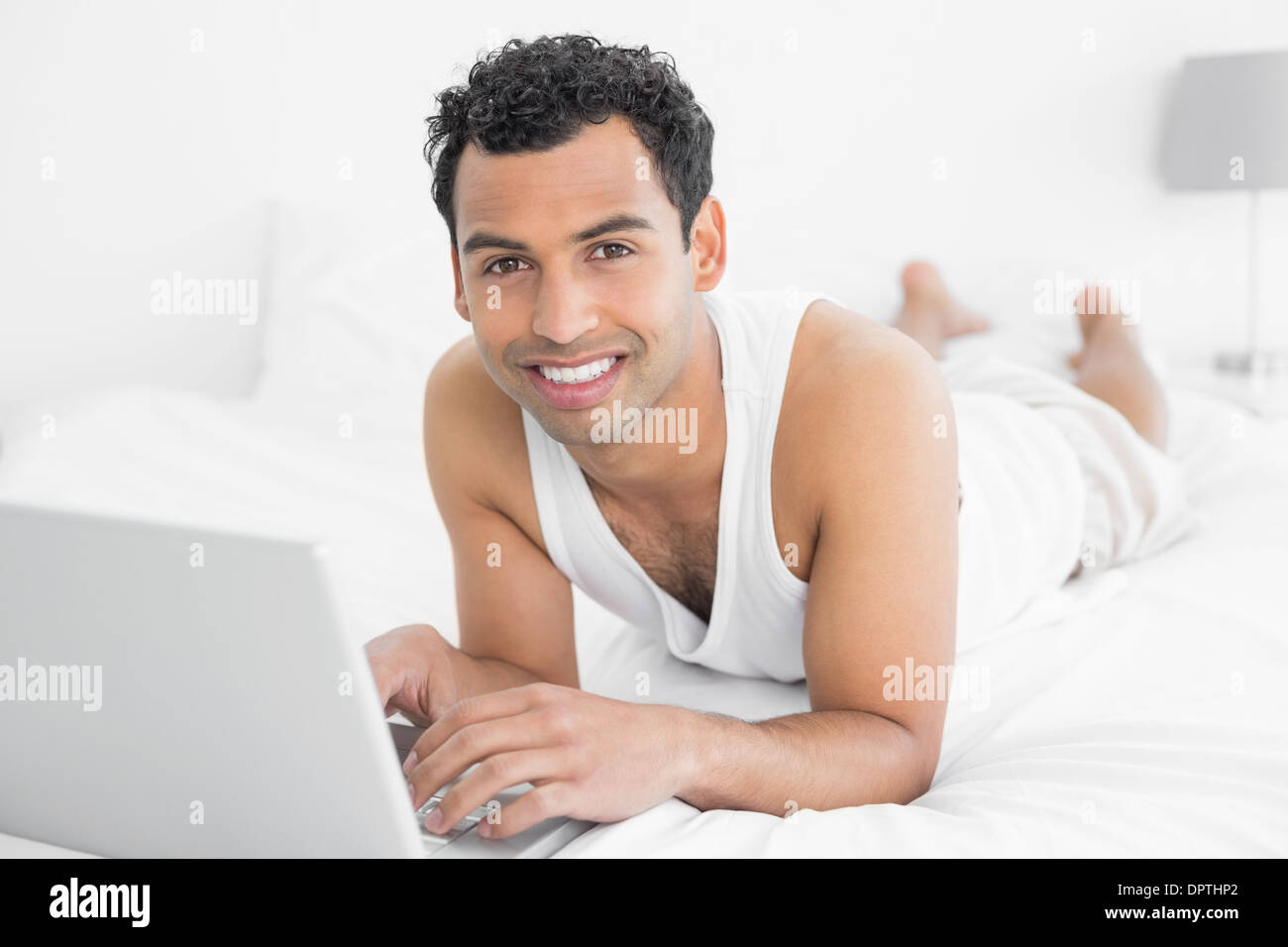 Smiling young man laptop hi-res stock photography and images - Alamy