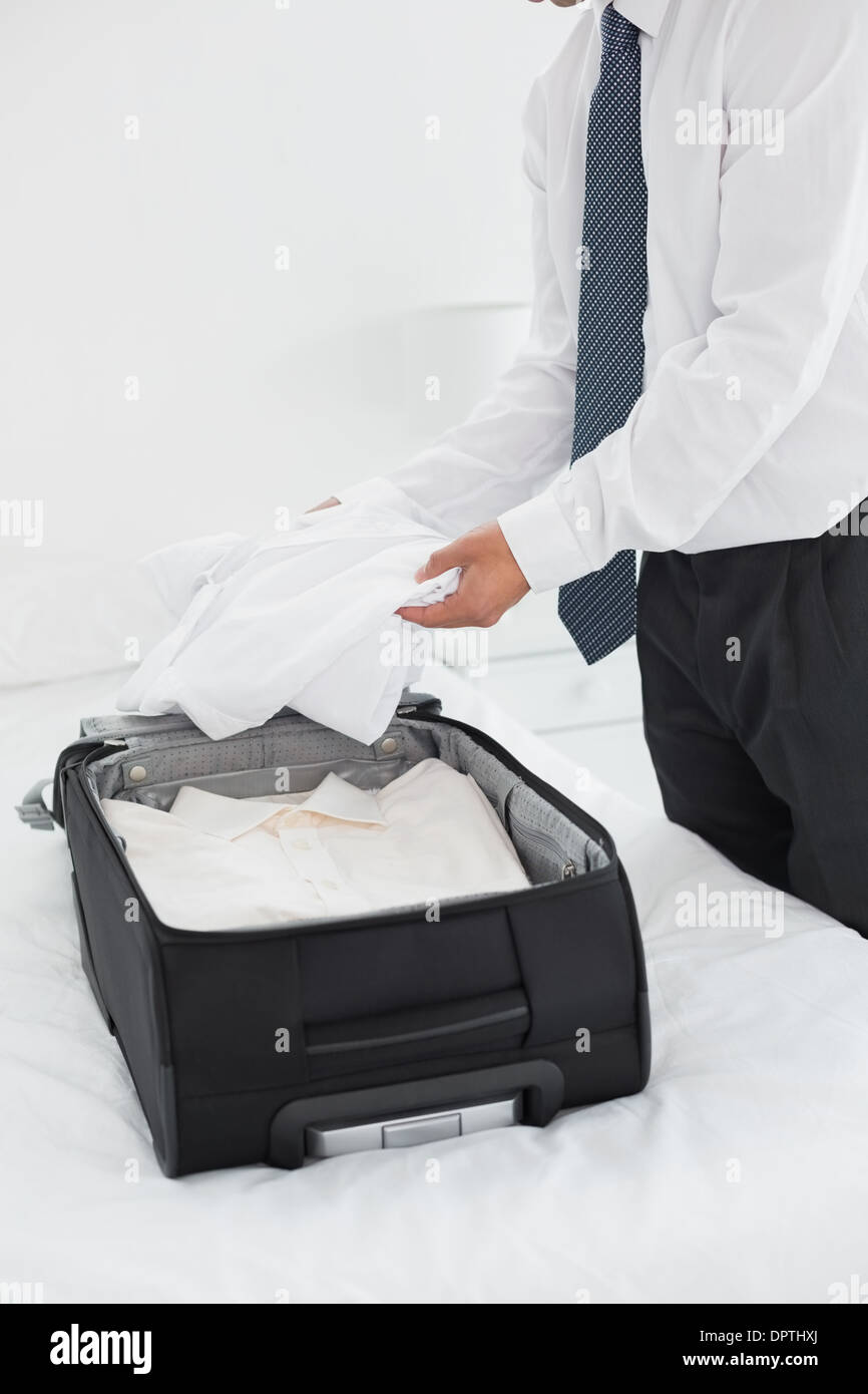 Businessman unpacking luggage at a hotel bedroom Stock Photo - Alamy