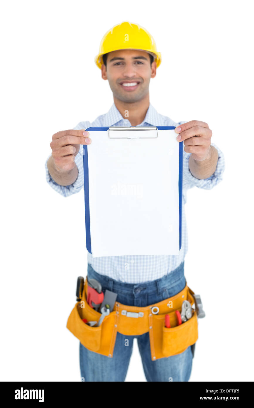 Smiling handyman in yellow hard hat holding clipboard Stock Photo - Alamy