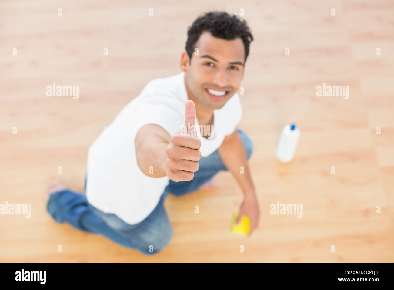 Smiling man cleaning the floor while gesturing thumbs up Stock Photo ...