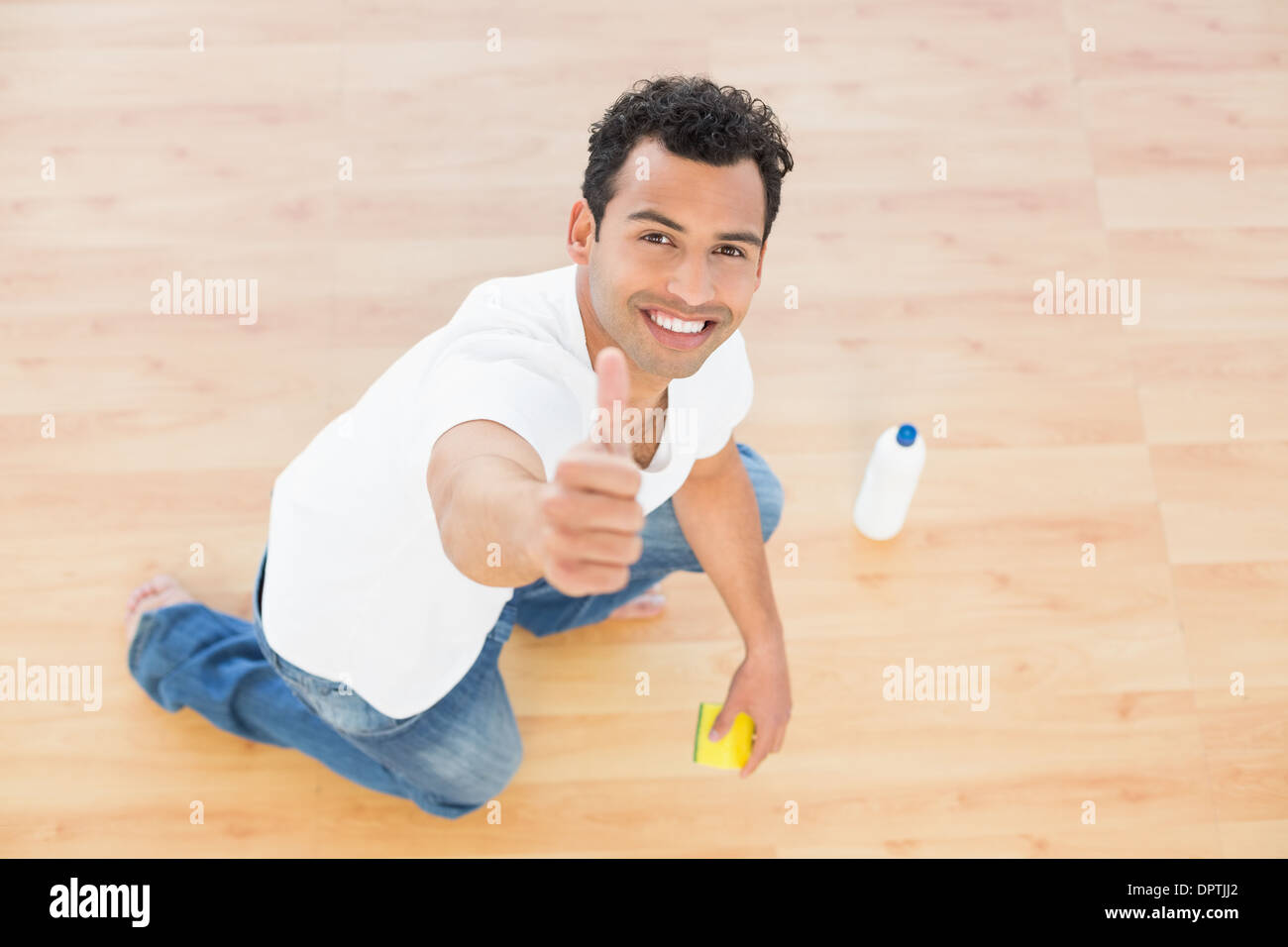 Smiling man cleaning the floor while gesturing thumbs up Stock Photo ...