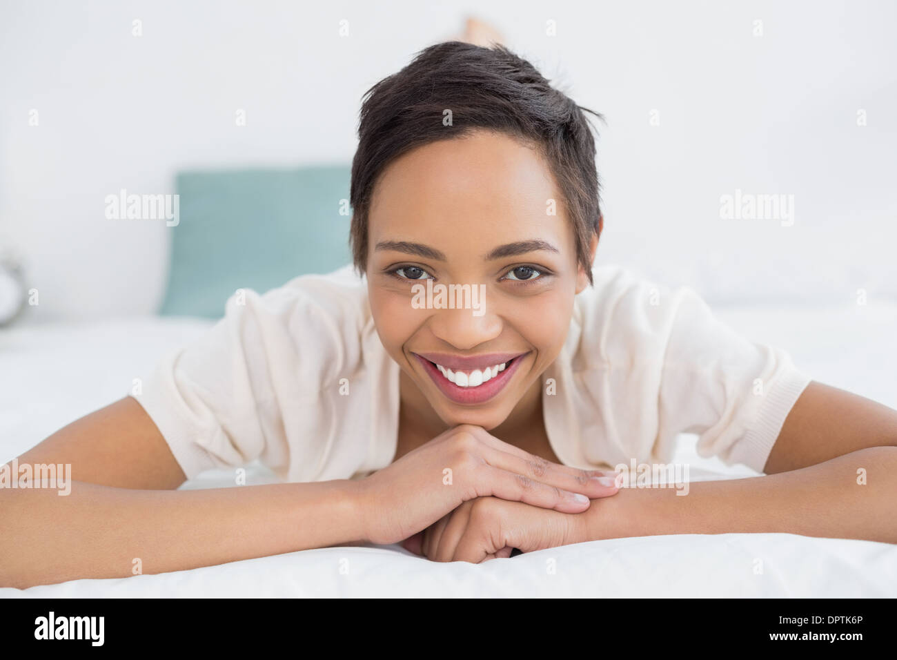 Smiling pretty young woman relaxing in bed Stock Photo - Alamy