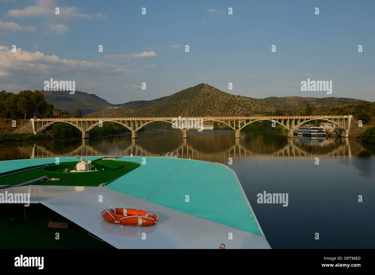 A Douro river cruise ship approaching the bridge at Barca d'Alva ...