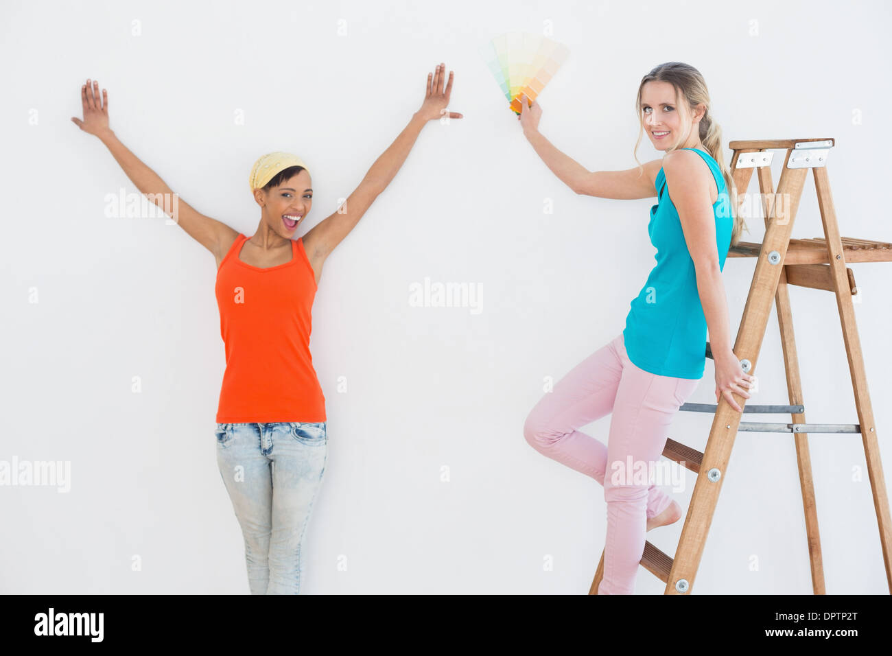 Happy friends with ladder choosing color for painting a room Stock ...